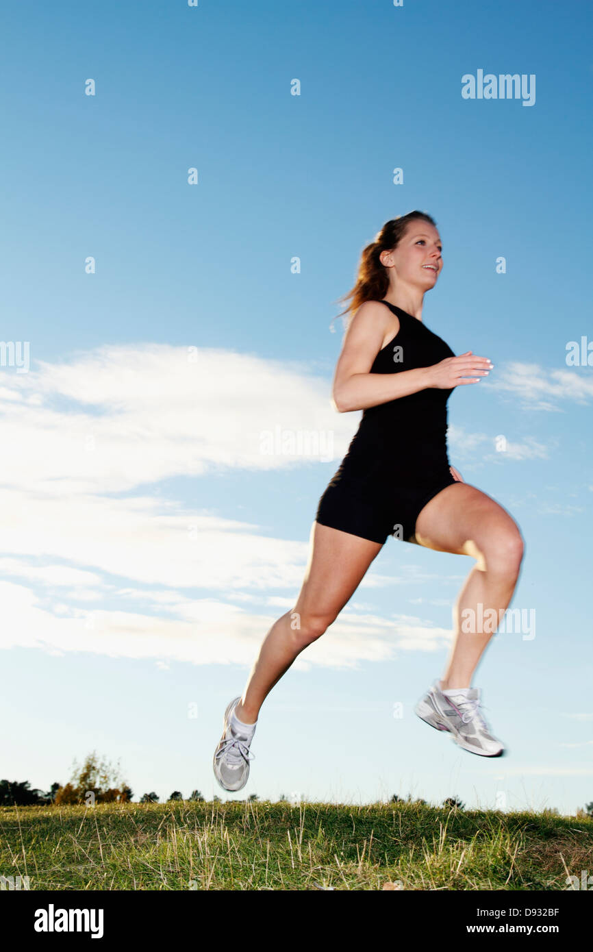 Young woman running Stock Photo - Alamy