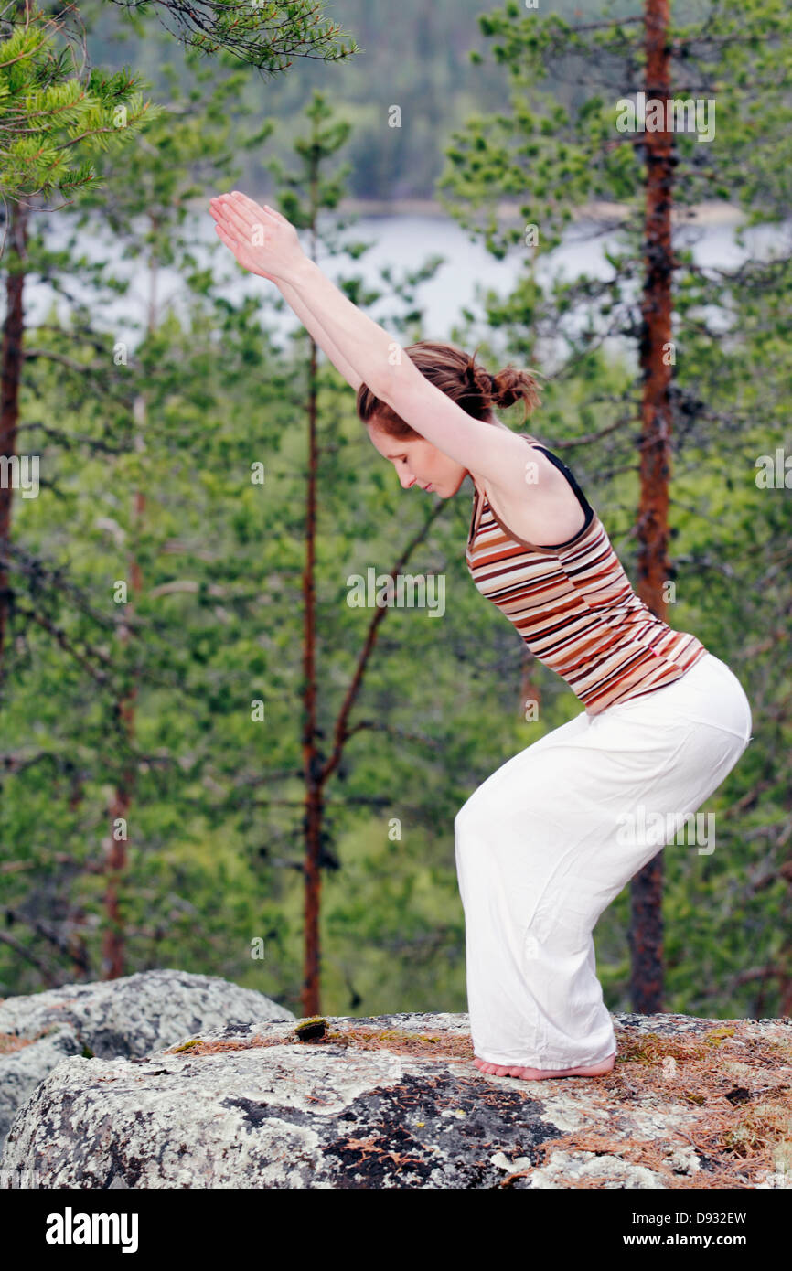 Woman standing doing yoga stretching hi-res stock photography and ...