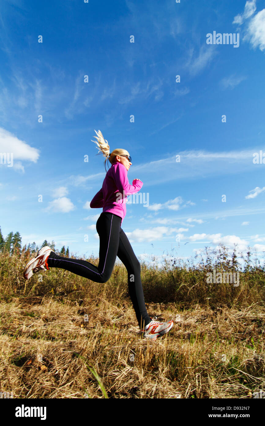 Young woman running Stock Photo - Alamy
