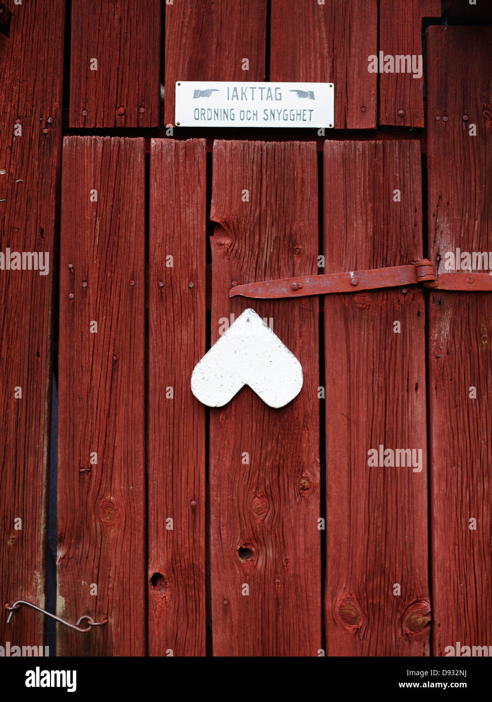 Heart shape decoration on door of outhouse Stock Photo - Alamy