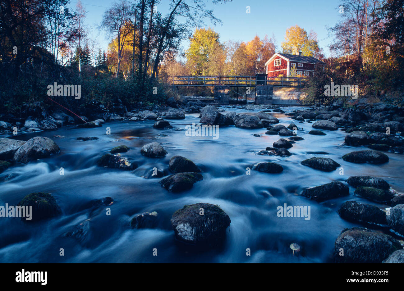 House and bridge besides stream Stock Photo - Alamy