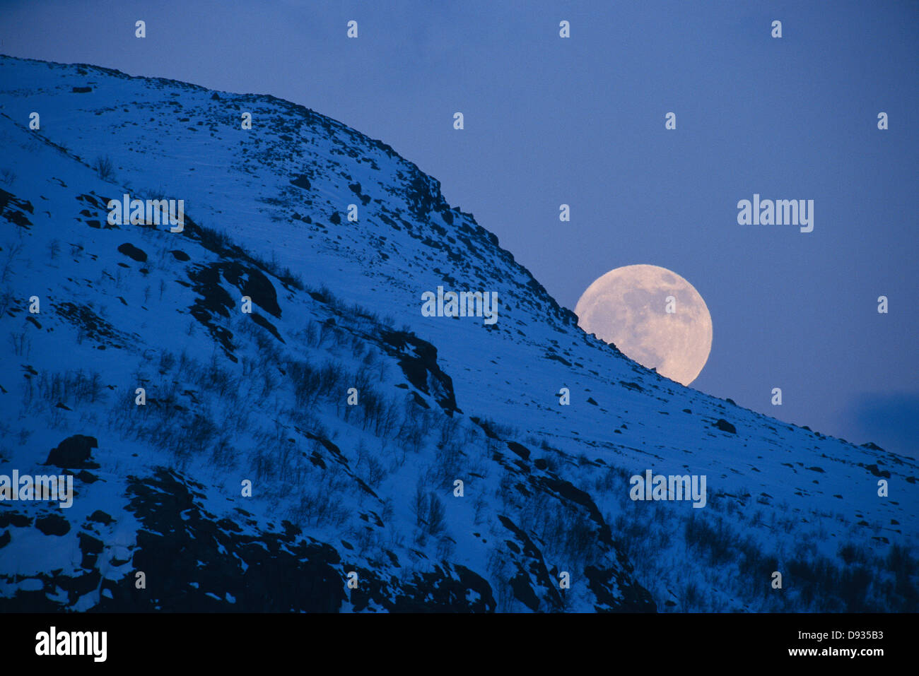 Full moon over mountains Stock Photo - Alamy