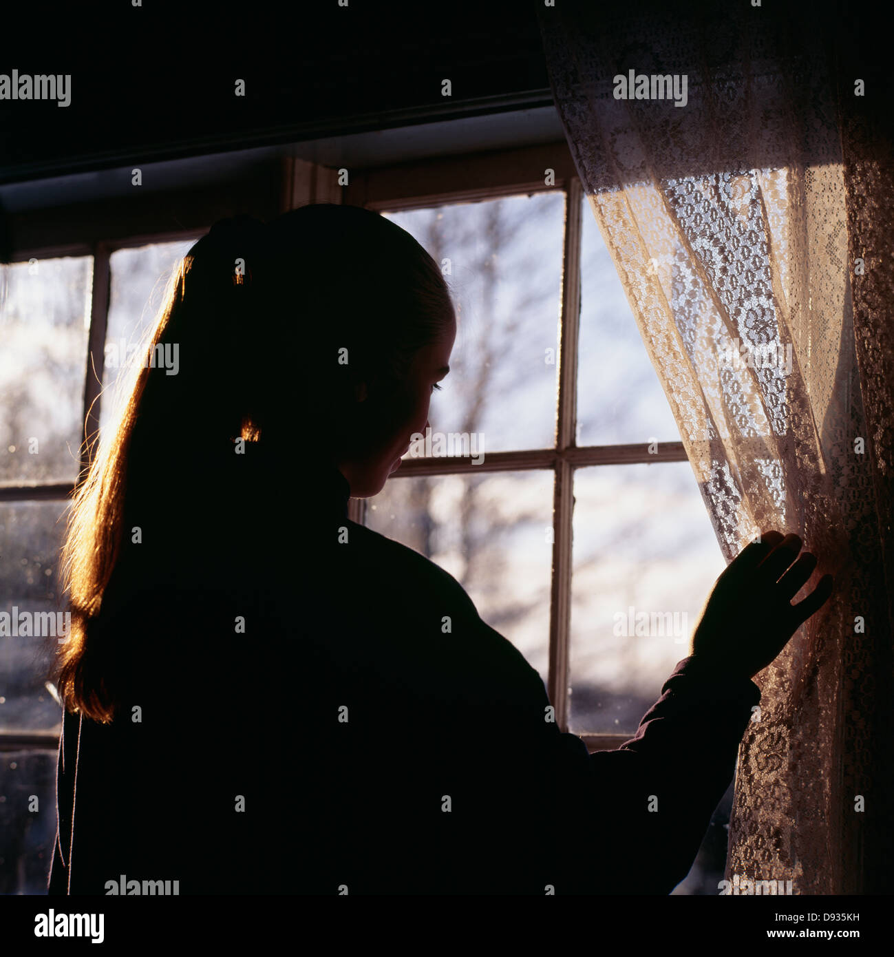 Silhouette of woman looking through window, rear view Stock Photo - Alamy