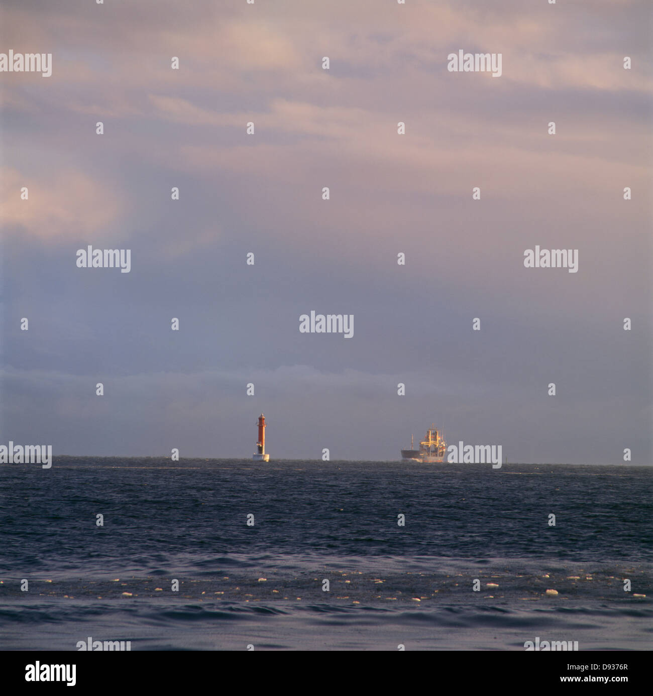 Vessel sailing towards lighthouse in sea Stock Photo - Alamy