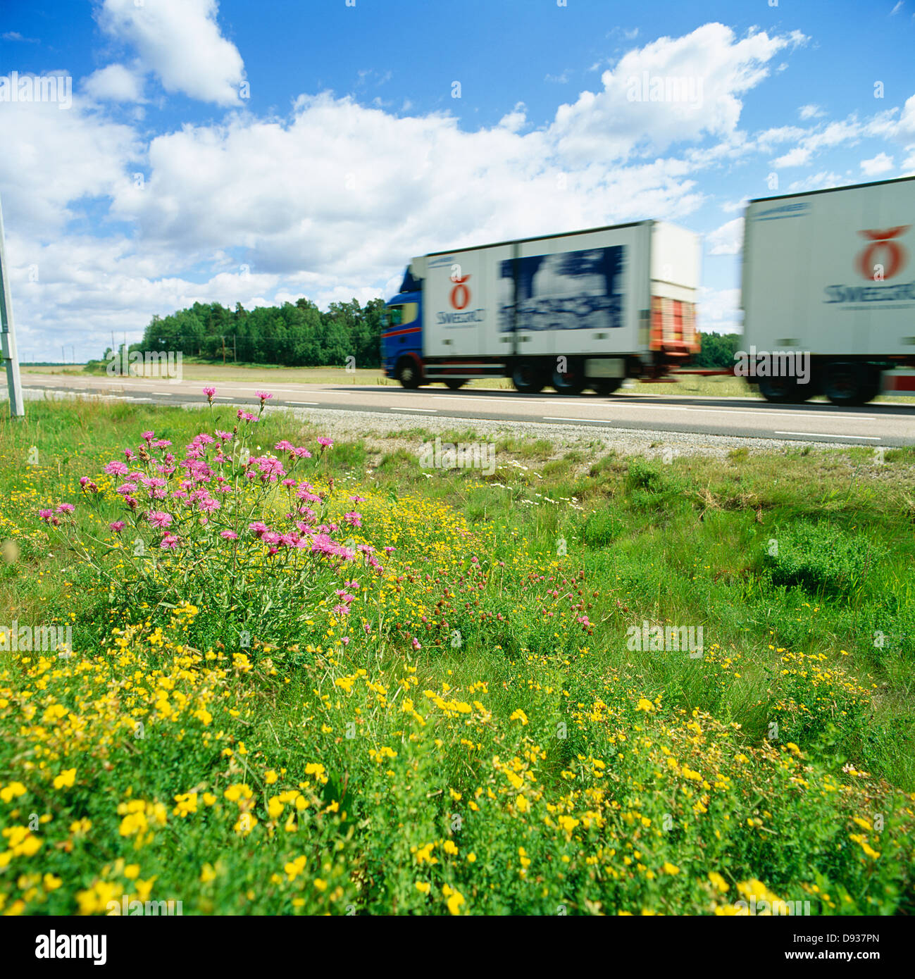Truck passing by meadow Stock Photo - Alamy