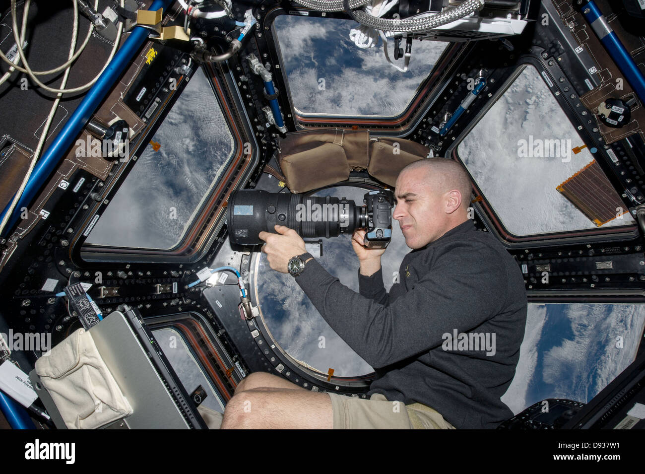ISS Expedition 36 NASA astronaut Chris Cassidy takes a photograph with ...