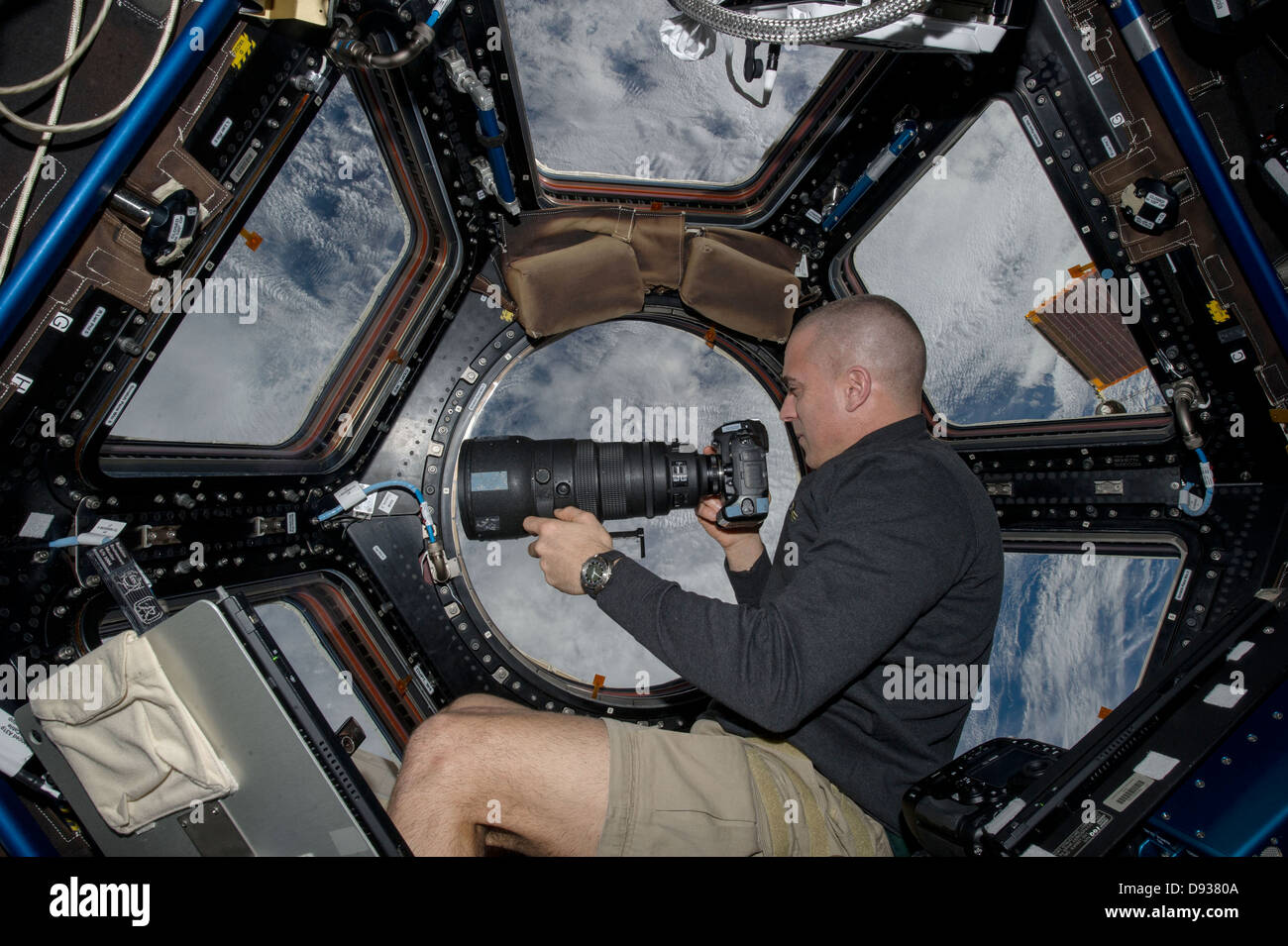 ISS Expedition 36 NASA astronaut Chris Cassidy takes a photograph with ...