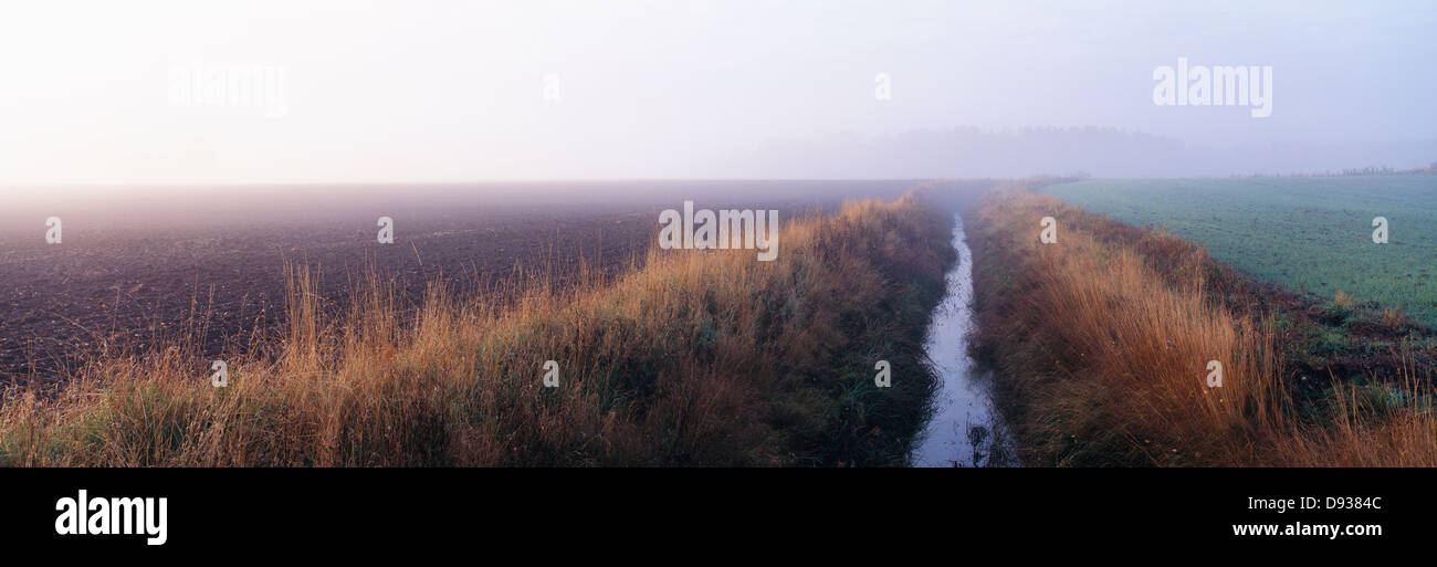 View of watercourse in field Stock Photo - Alamy