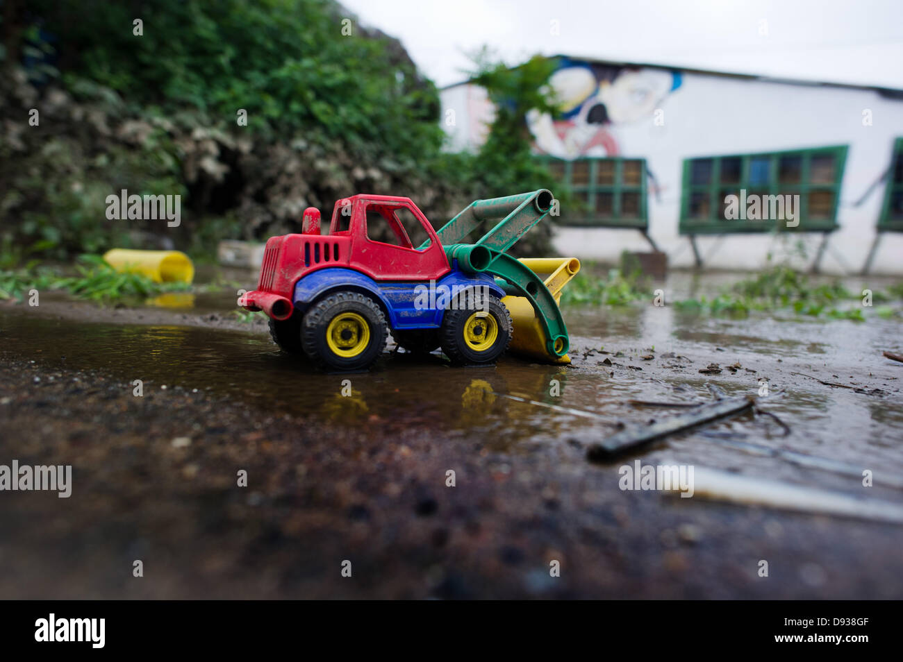 A toy digger is visible in a garden destroyed by floodwater at an ...