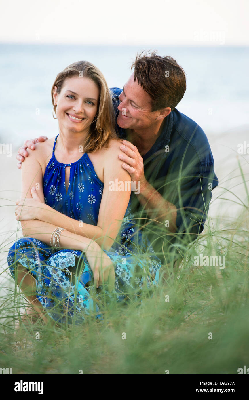 Couple smiling together on beach Stock Photo - Alamy