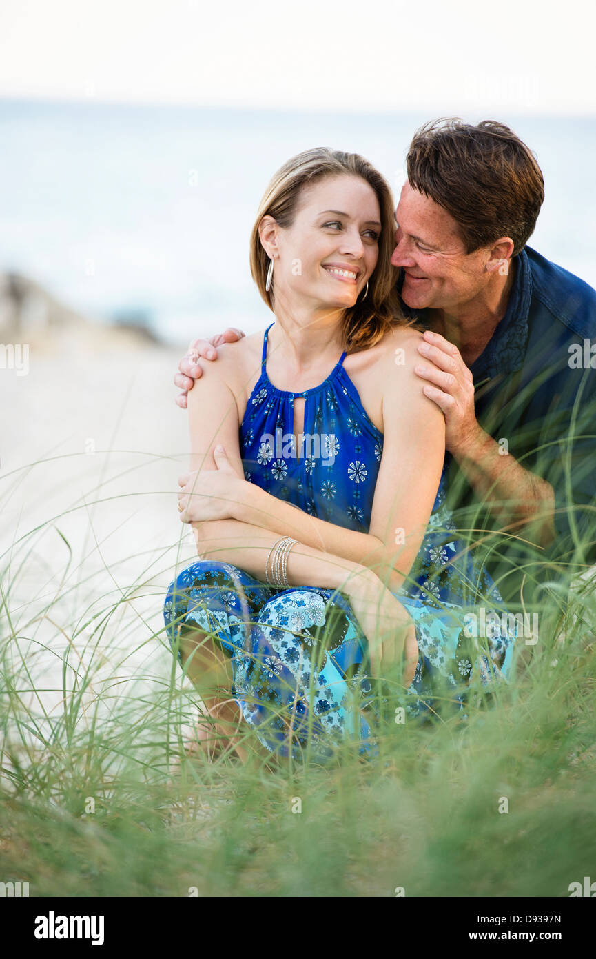 Couple smiling together on beach Stock Photo - Alamy
