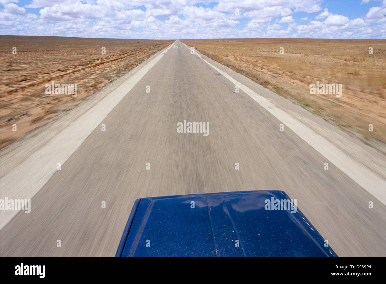 A car on a road in a flat countryside Stock Photo - Alamy