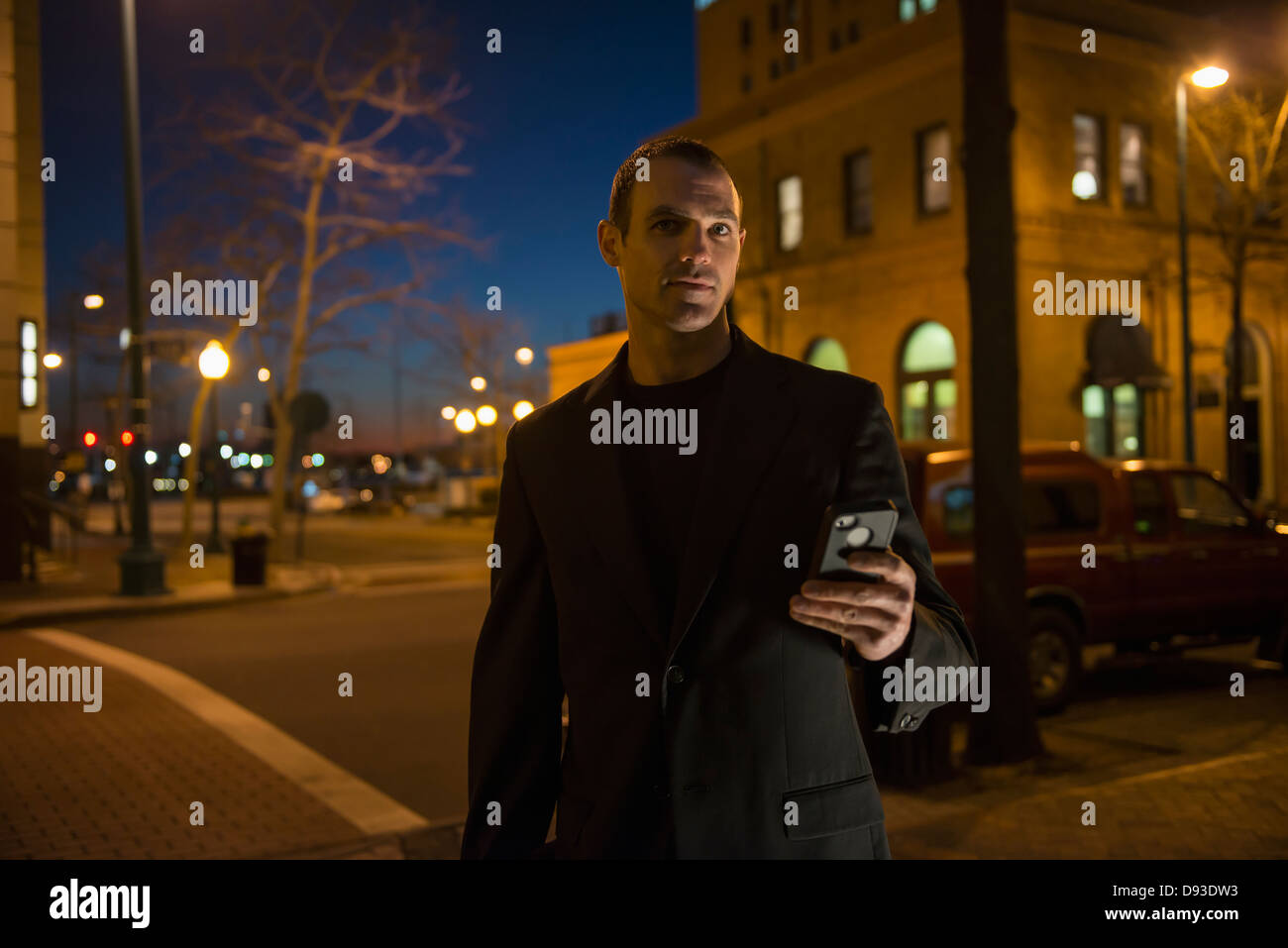 Caucasian man using cell phone on city street Stock Photo - Alamy
