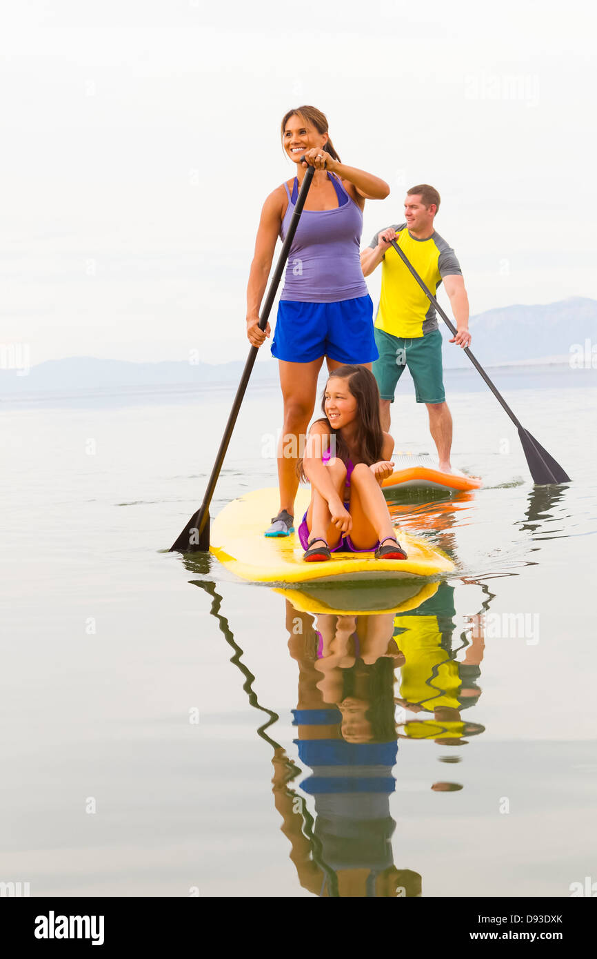 Family riding paddle boards Stock Photo - Alamy