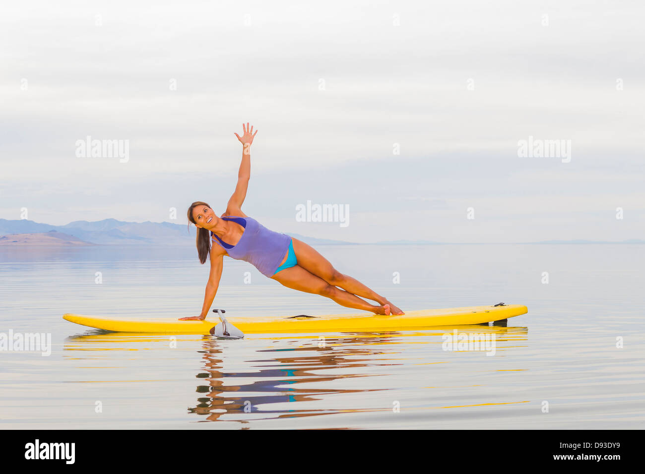 Filipino woman practicing yoga on paddle board Stock Photo - Alamy