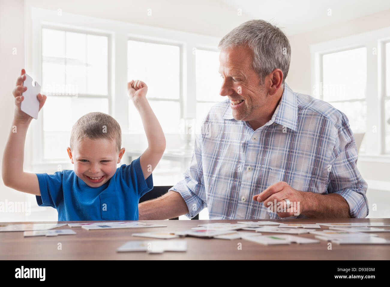 Caucasian father and son playing cards Stock Photo - Alamy