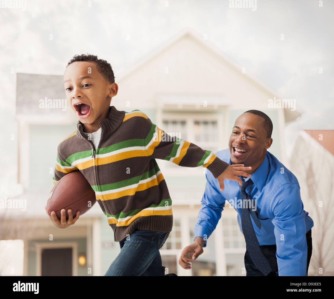Father and son playing football Stock Photo - Alamy