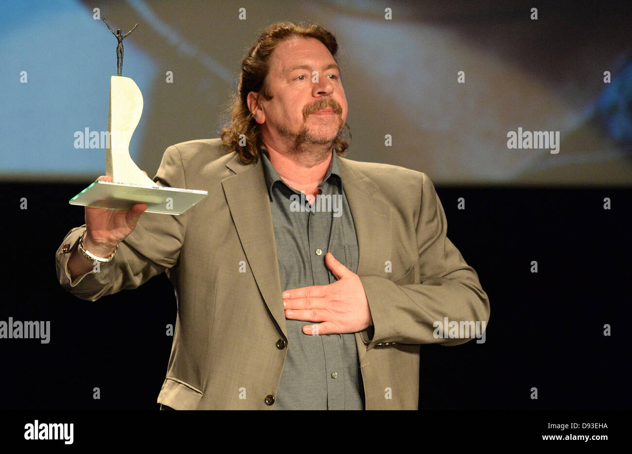 German actor Armin Rohde cheers as he receives the acting award at the ...