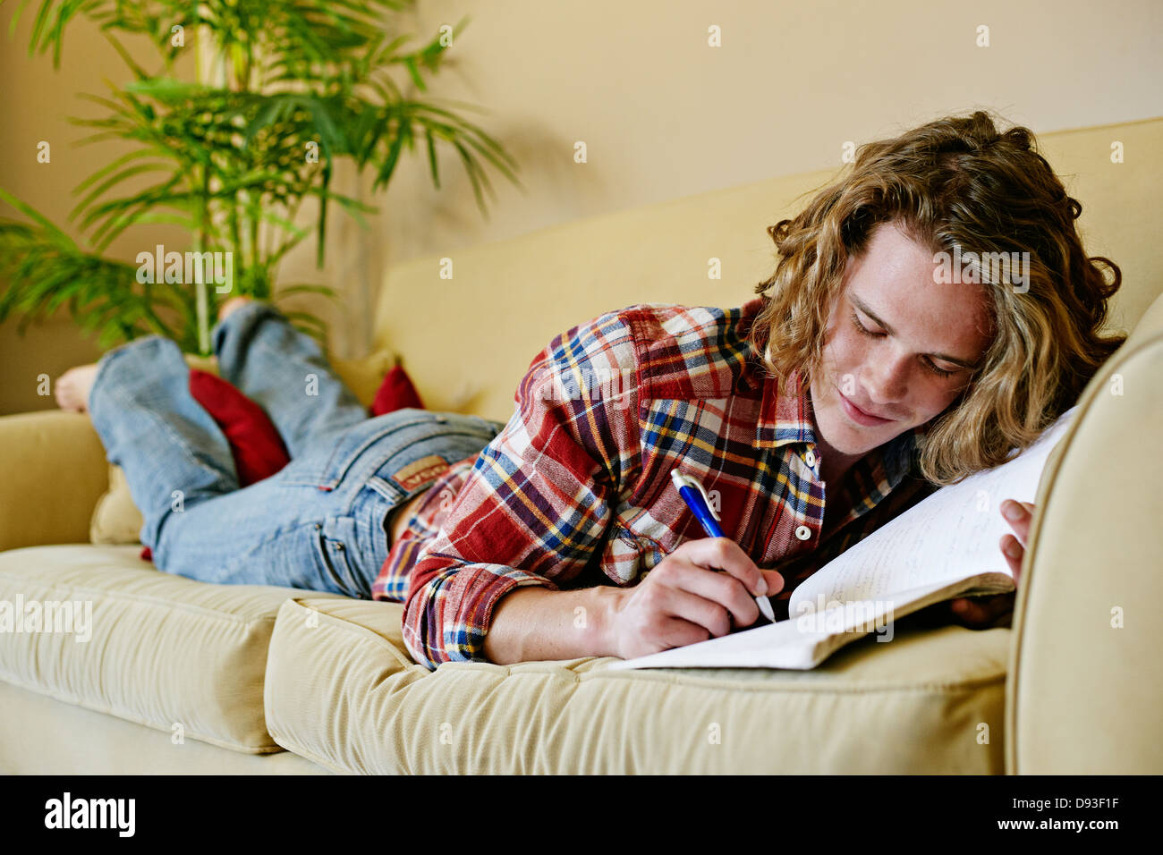 Caucasian man drawing on sofa Stock Photo - Alamy