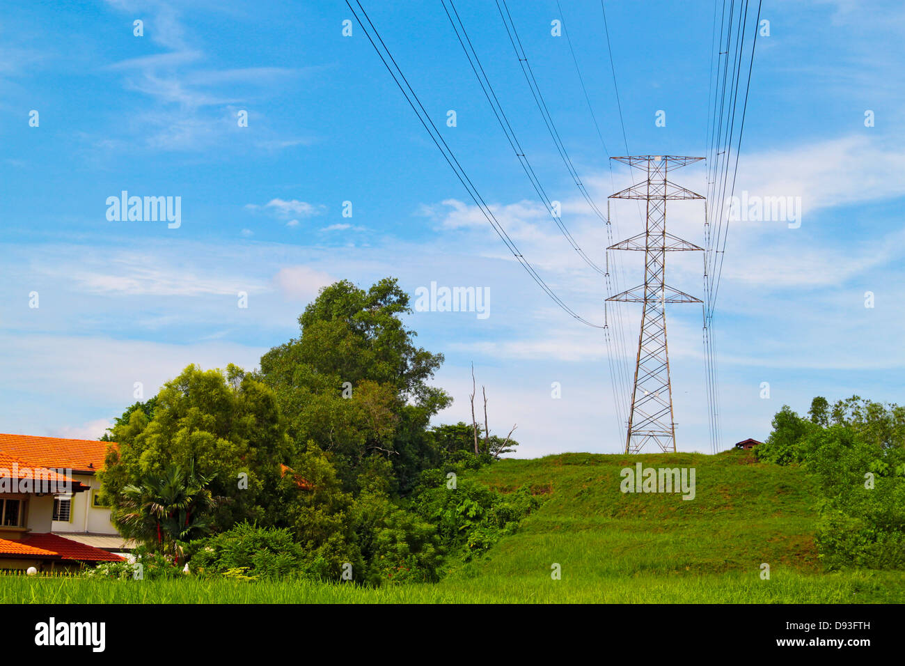 Power cable tower on a hill near housing area. Concept of power ...
