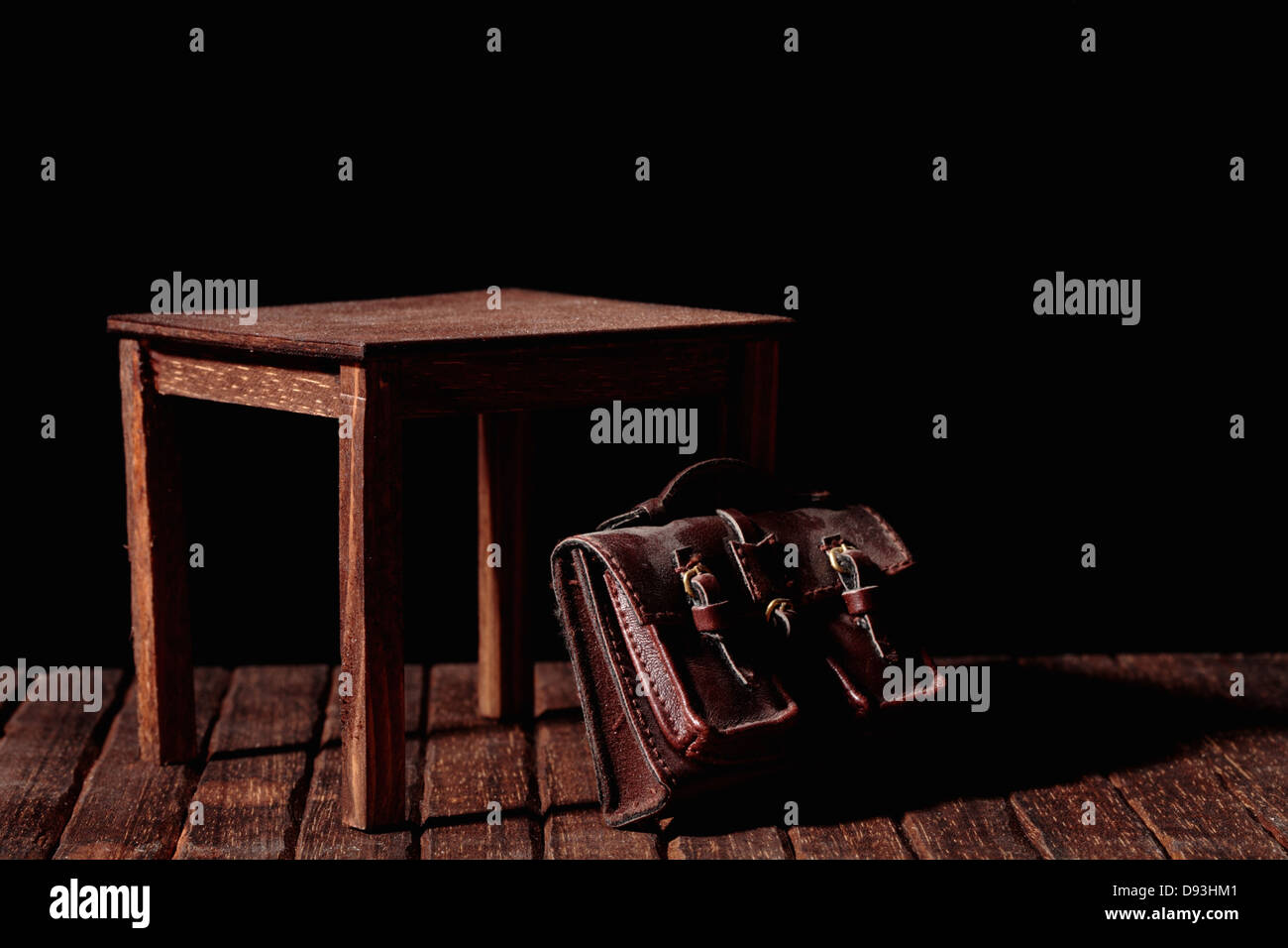 a vintage bag under an old and wooden table Stock Photo - Alamy