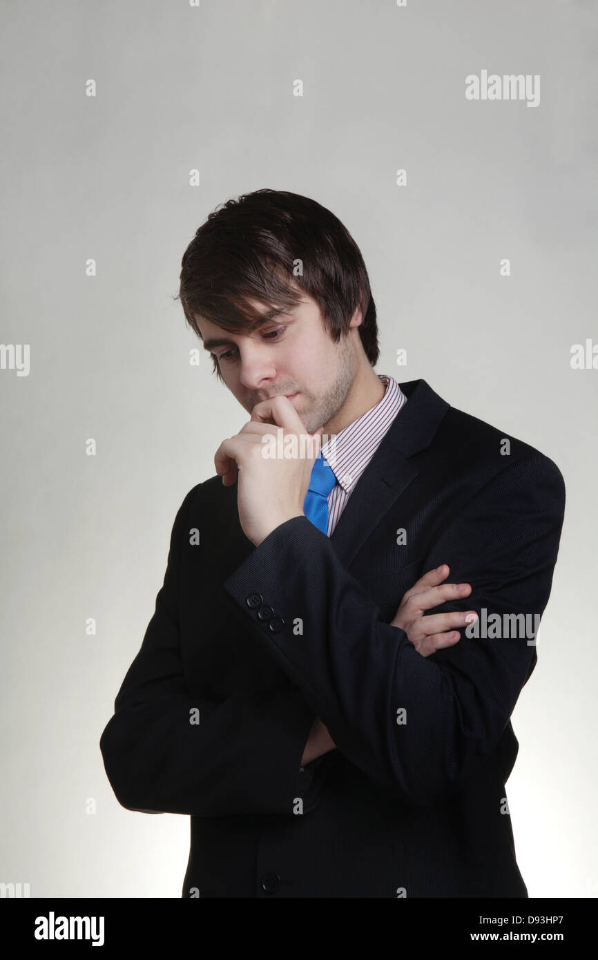 business man thinking looks deep in thought Stock Photo - Alamy
