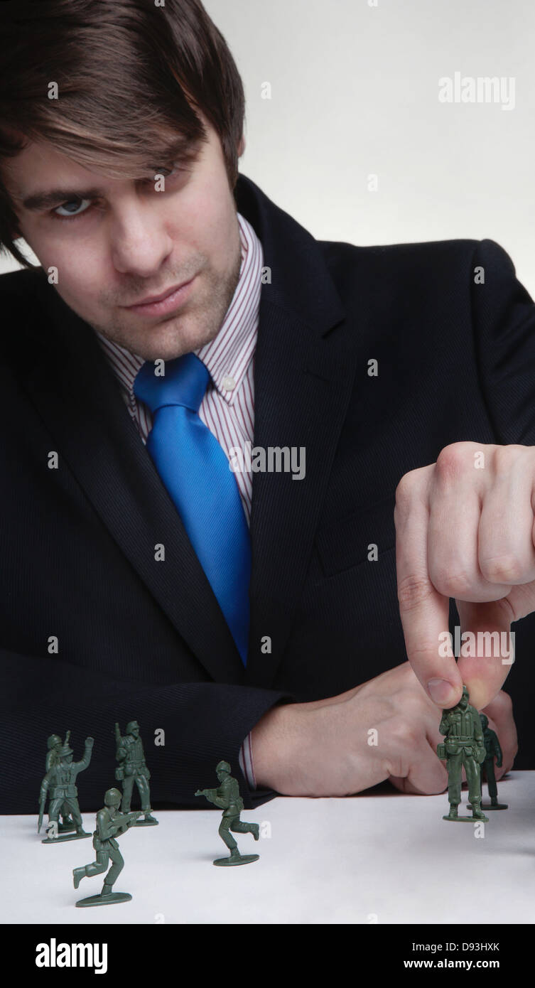 business man playing with toy soldiers Stock Photo - Alamy