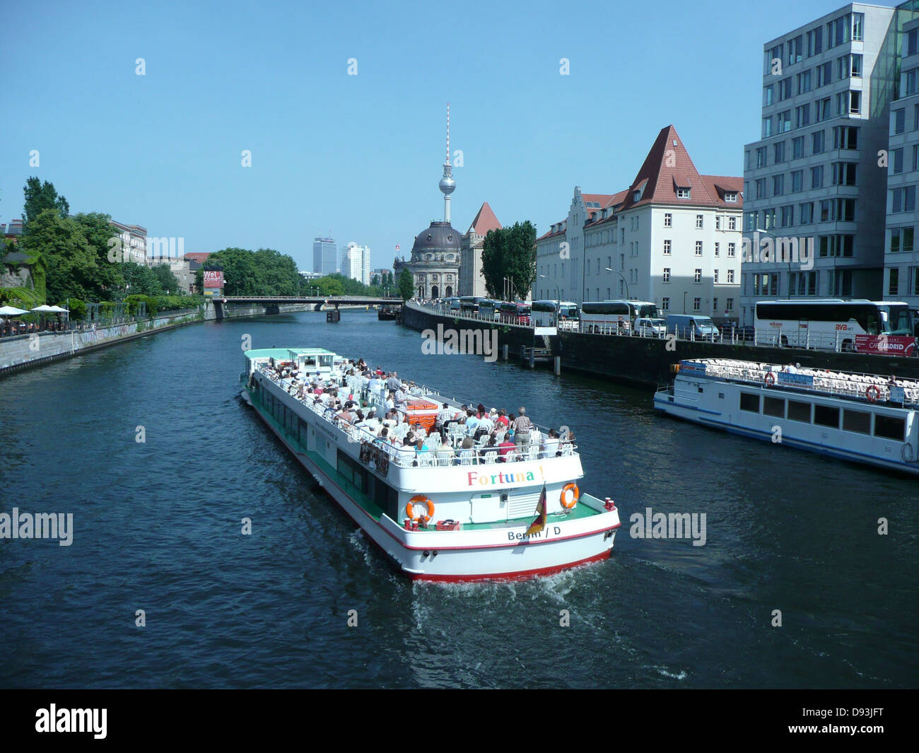 A boat cruises along the river in Berlin, Germany, offering views of ...