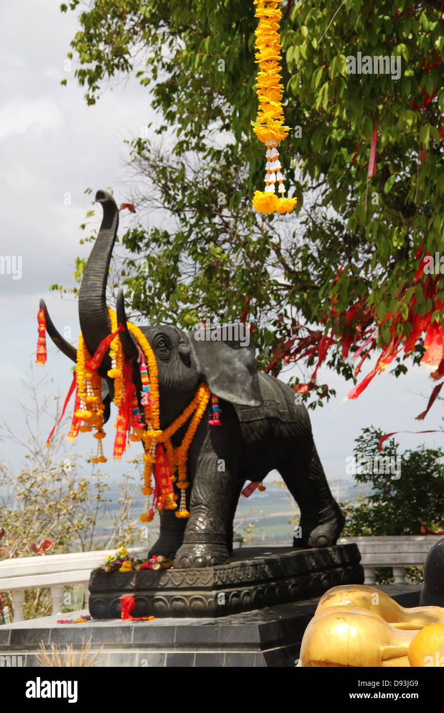Elephant religious statue with hanging flower garlands Stock Photo - Alamy