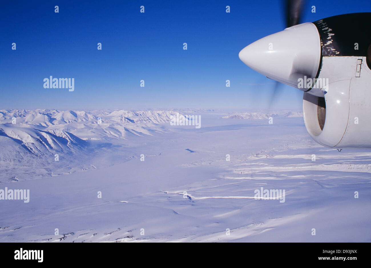 Airplane over snow Stock Photo - Alamy
