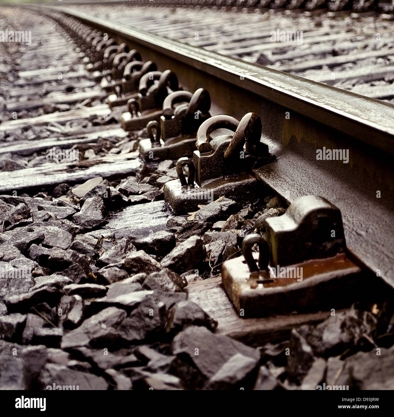 The image shows a close-up view of an iron railroad track, highlighting ...