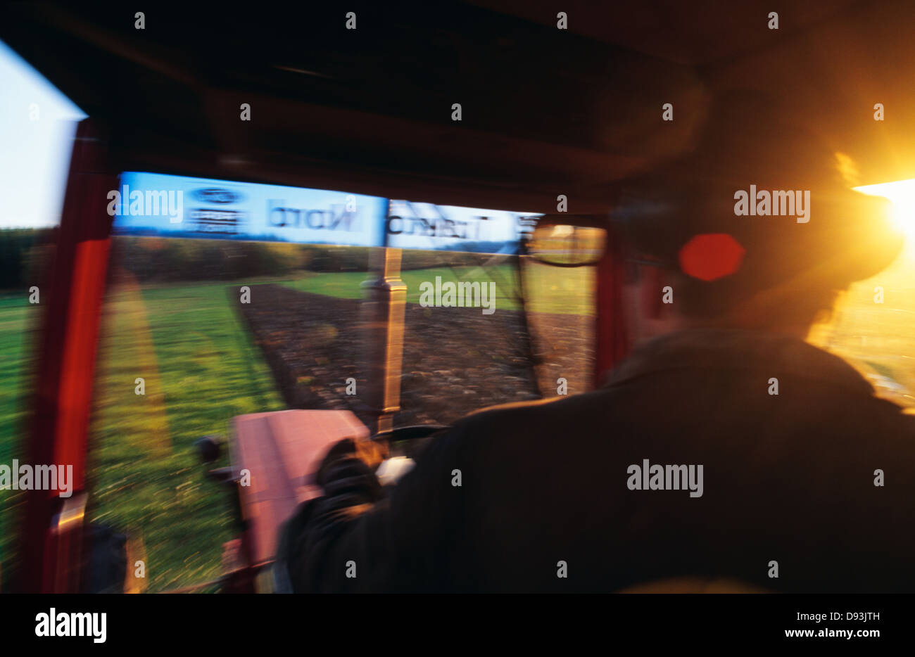 Man driving tractor in field, rear view Stock Photo - Alamy