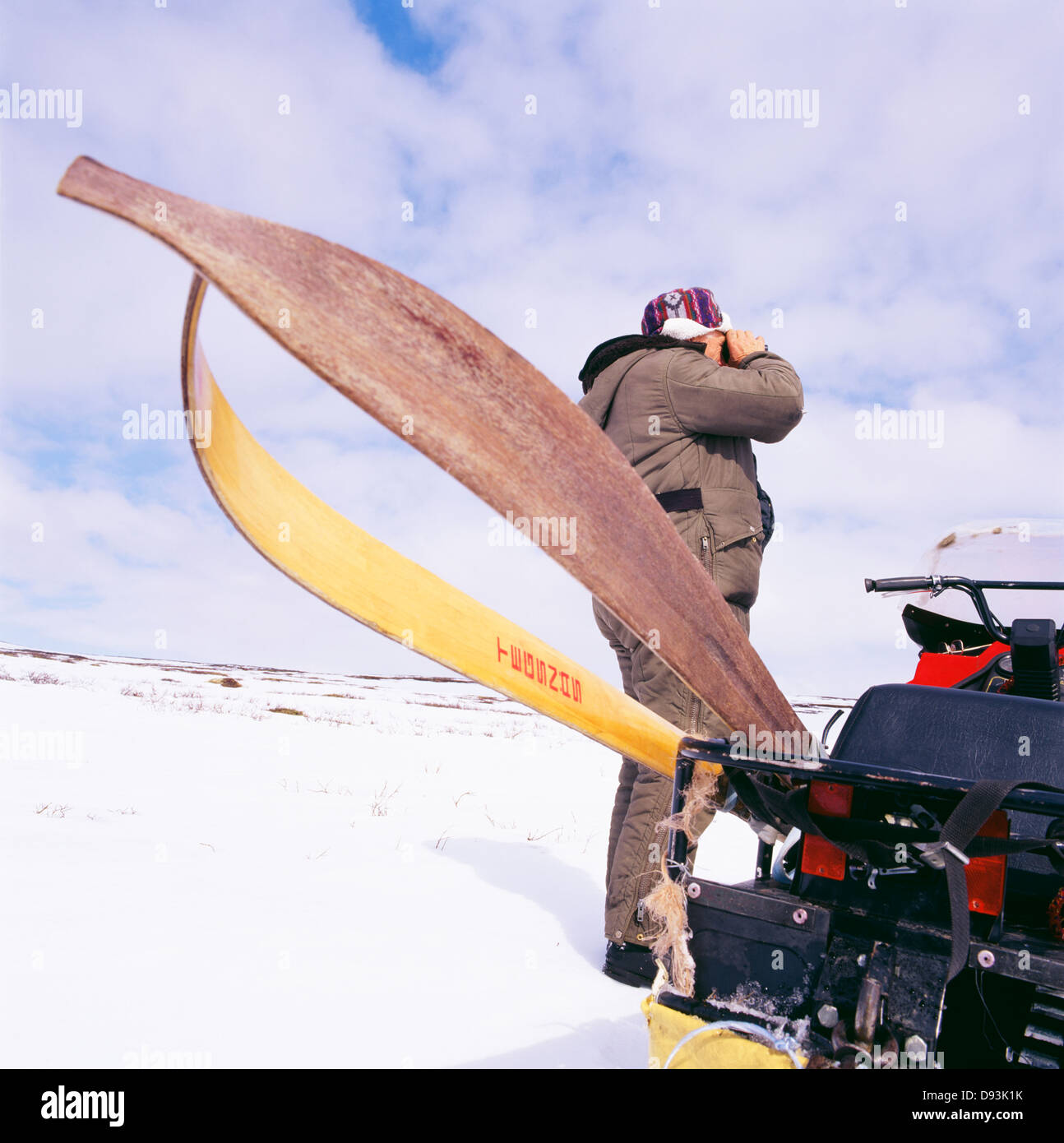 Man standing by skis, side view Stock Photo - Alamy