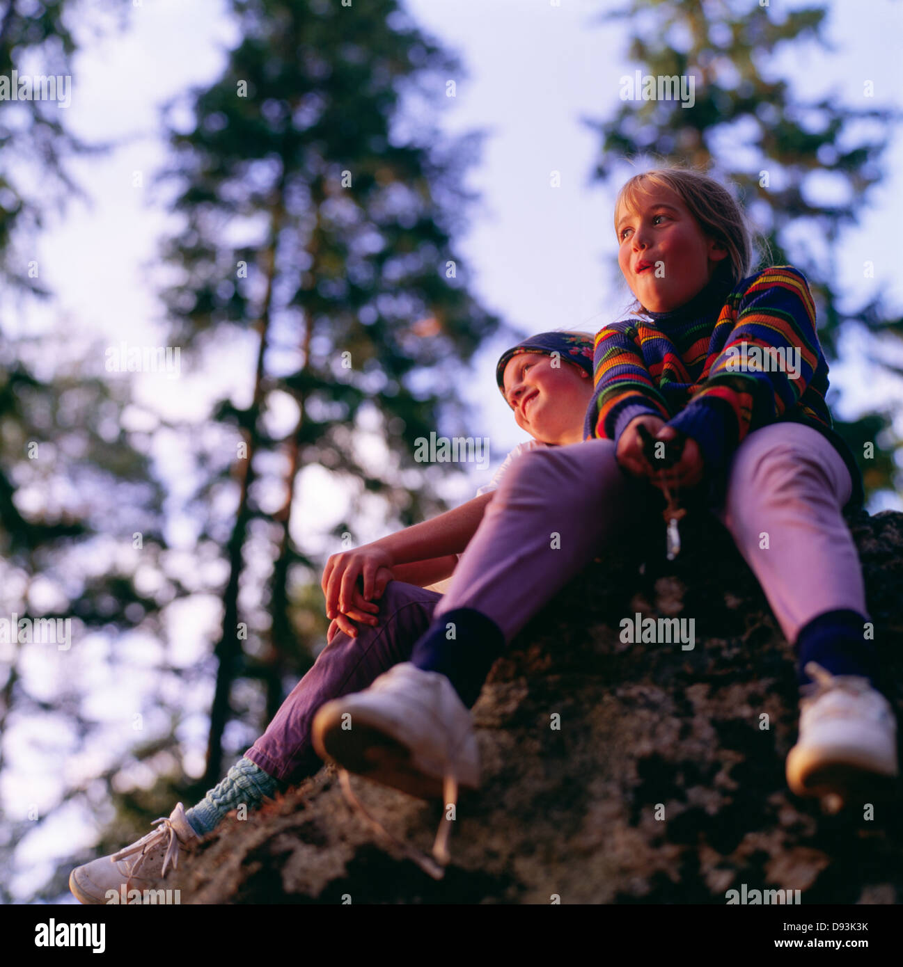 Children sitting on rock Stock Photo - Alamy