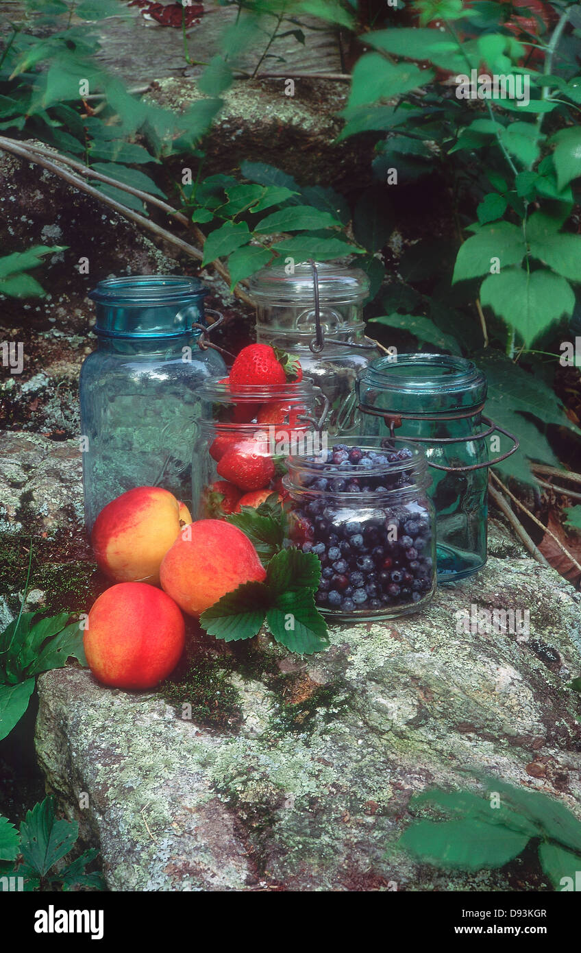 Fruit and berries with old-fashioned home preserving jars. Photograph ...