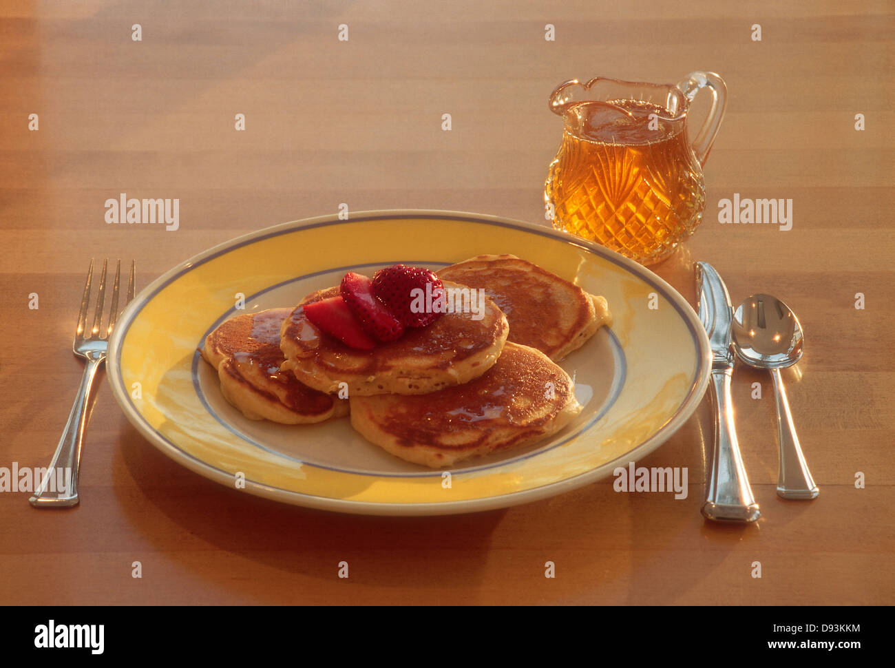 Pancakes and strawberries with homemade maple syrup for breakfast ...