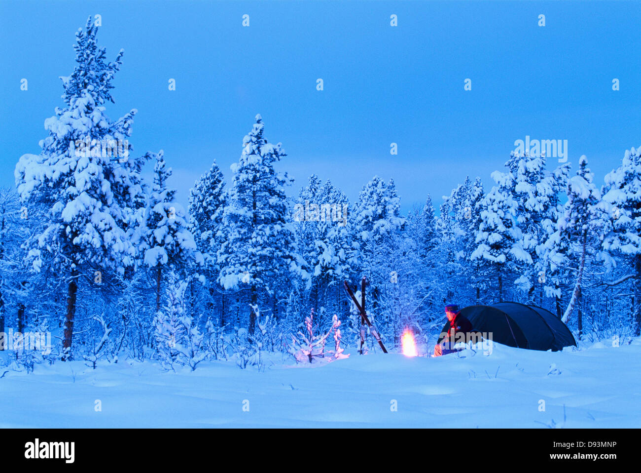 Man sitting near fire Stock Photo - Alamy