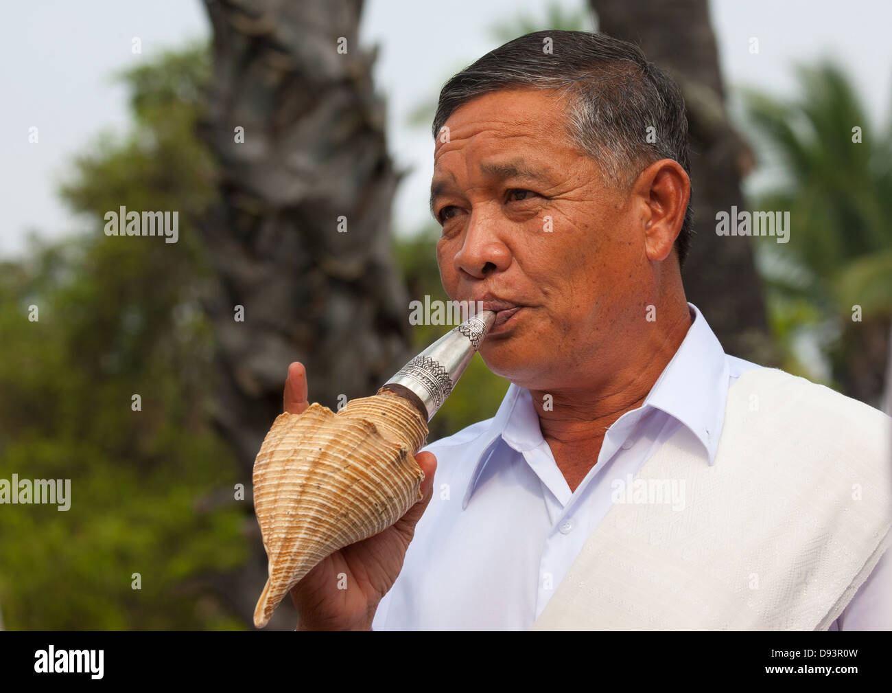 Man blowing shell hi-res stock photography and images - Alamy