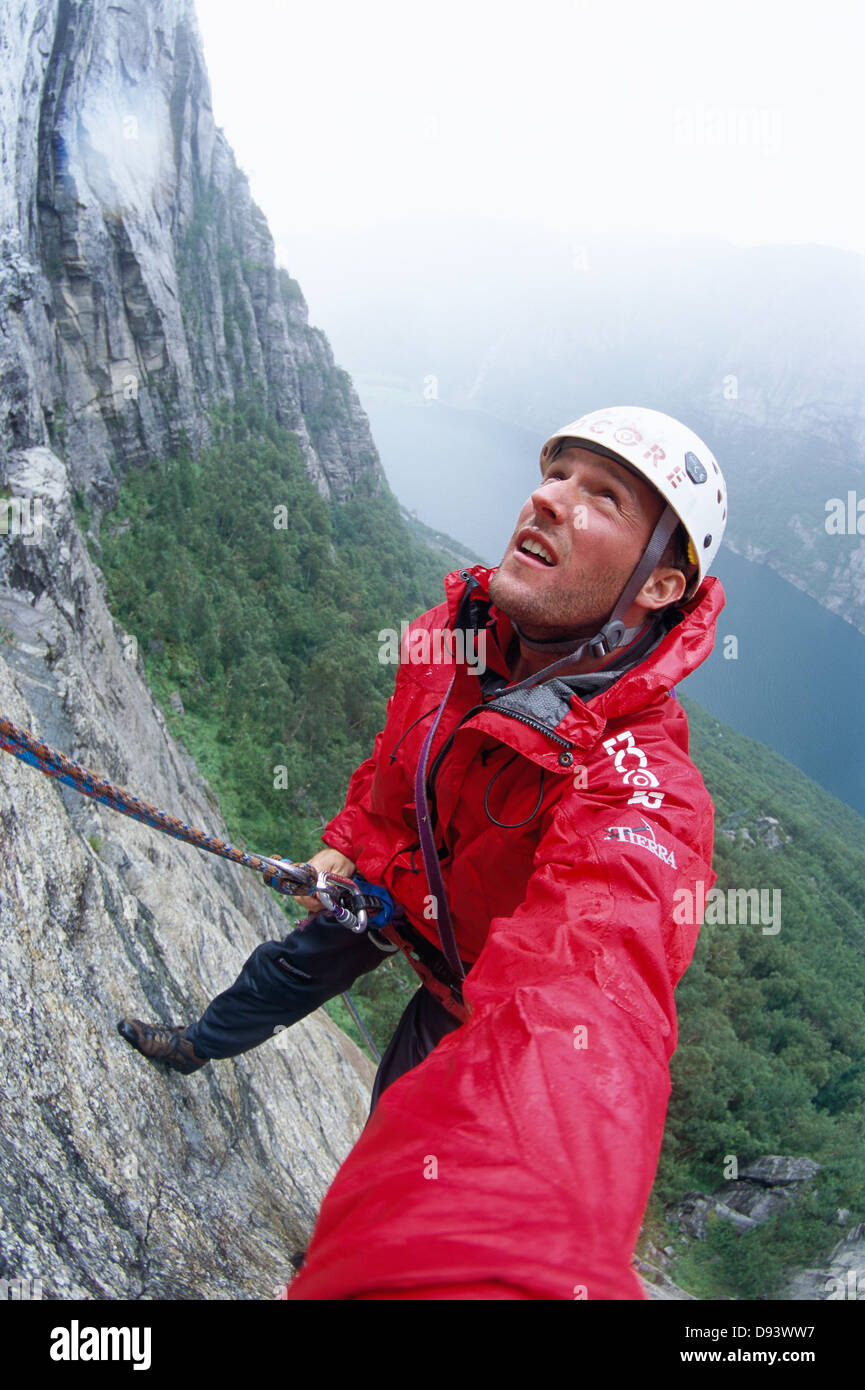 A man climbing a mountain Stock Photo - Alamy