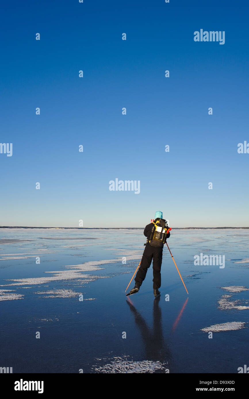 Man ice skating on snow covered landscape Stock Photo - Alamy