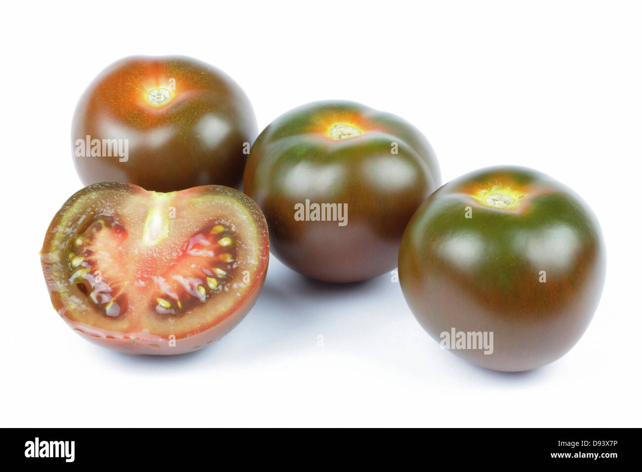kumato tomatoes on the white background Stock Photo - Alamy
