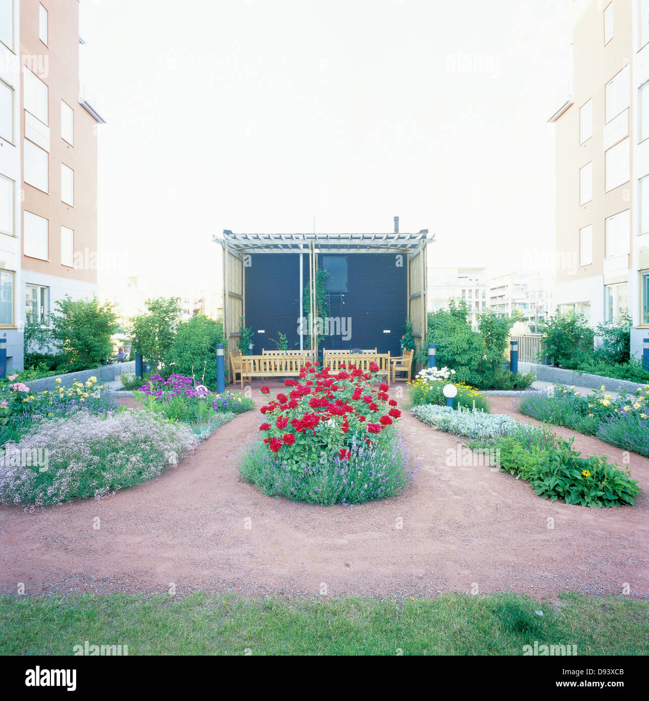 Flower bed between houses Stock Photo - Alamy