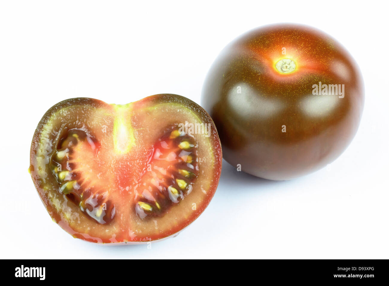 kumato tomatoes on the white background Stock Photo - Alamy