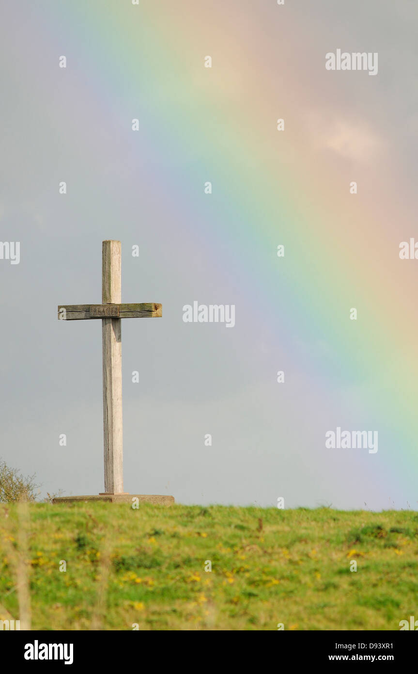 Large wooden cross in a field with a rainbow in background Stock Photo ...