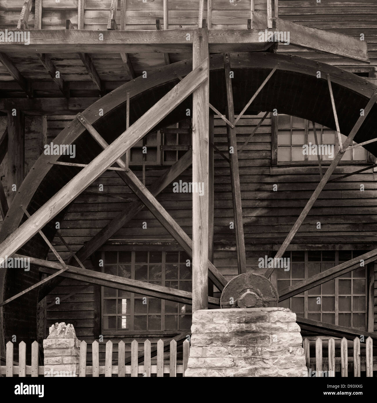 The exterior of a grist mill showing a portion of the water wheel at ...
