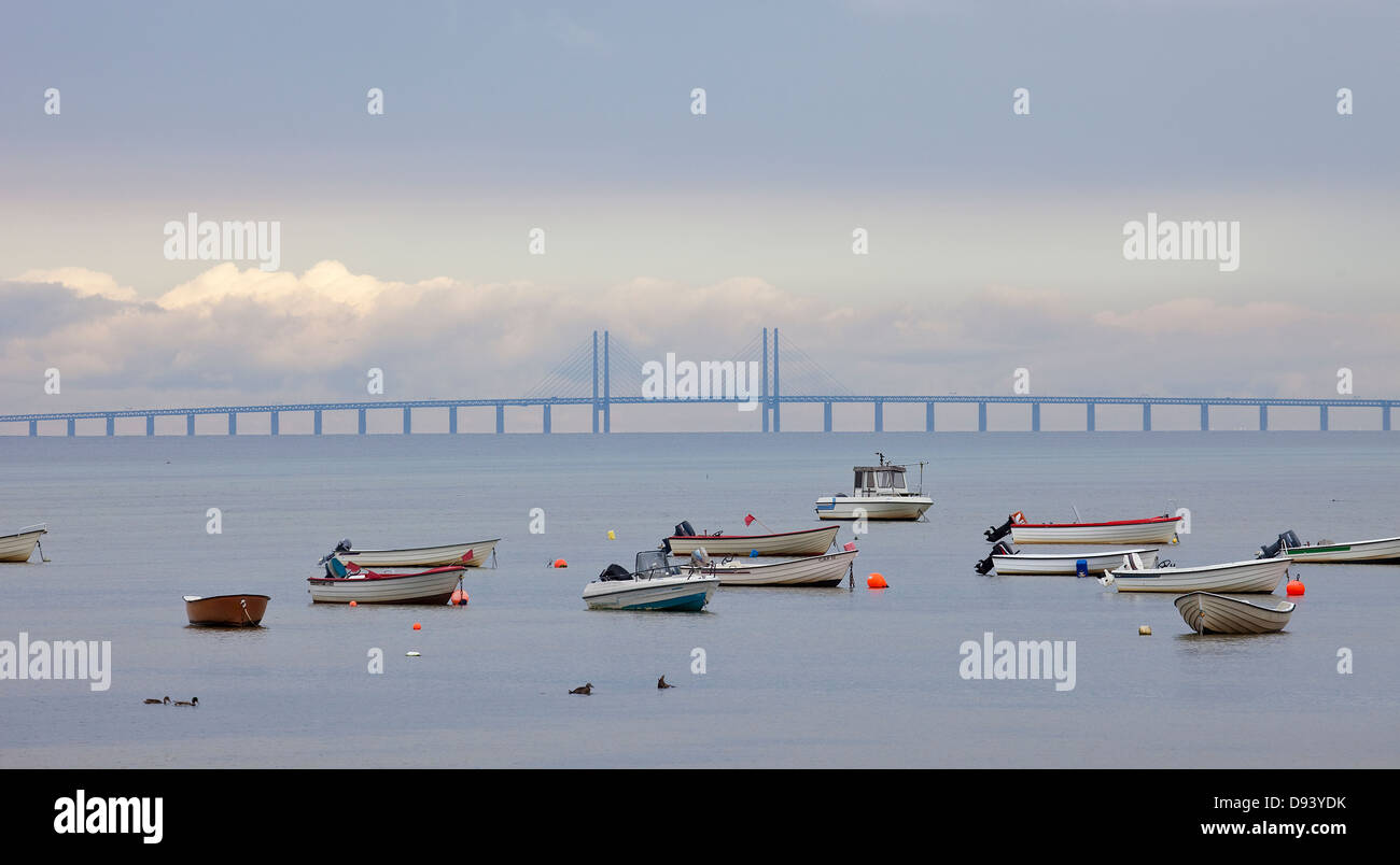 View of fishing boats on sea with bridge in background Stock Photo - Alamy