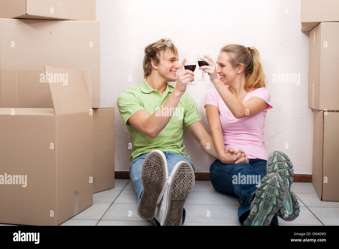 young couple celebrating their first new home Stock Photo - Alamy