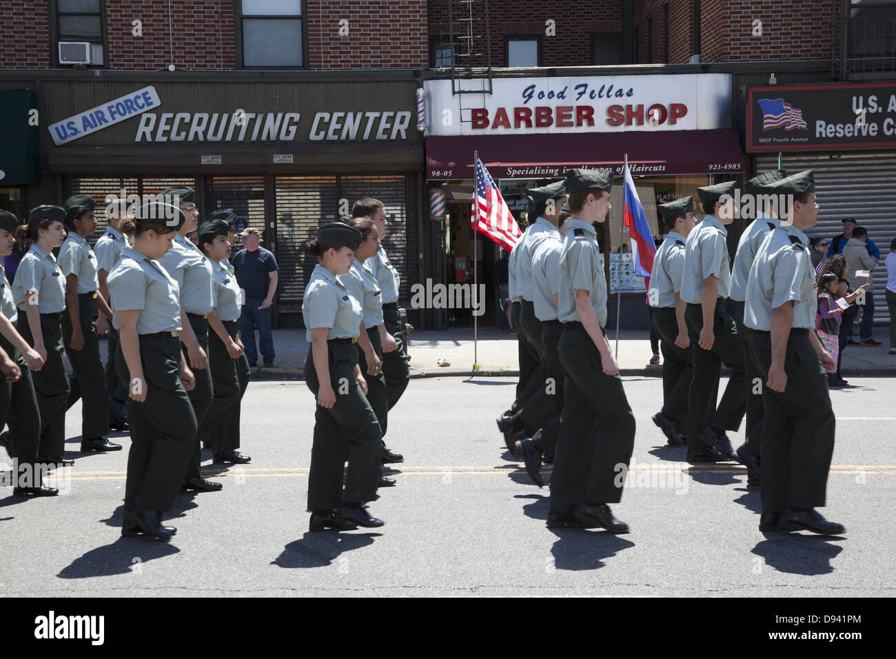 Members of high school ROTC pass a local military recruitment office ...