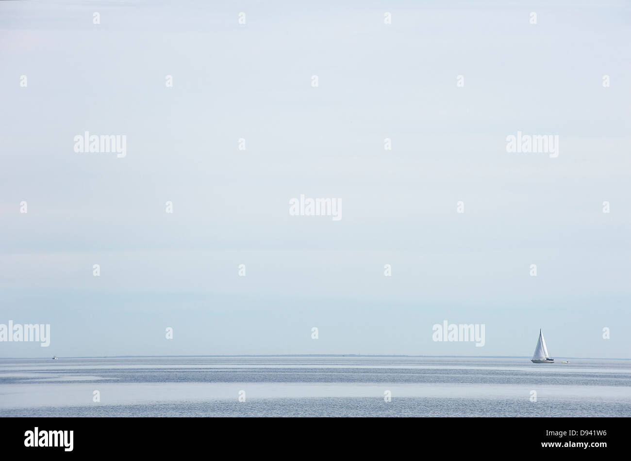 Distant view of sailboat on sea Stock Photo - Alamy