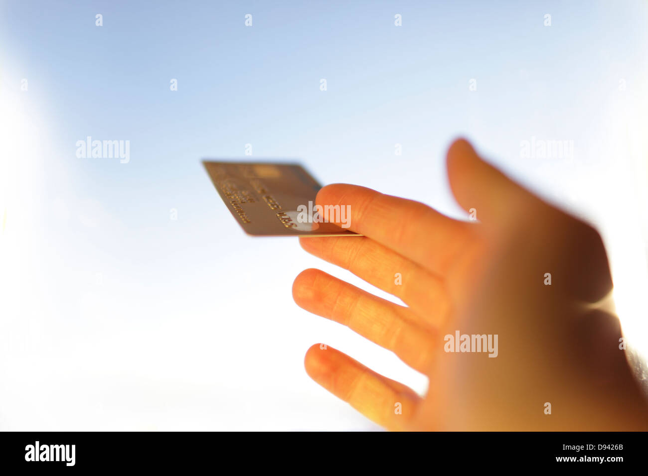 Human hand holding gold credit card, studio shot Stock Photo - Alamy